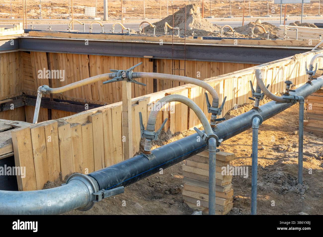 A close-up view of a series of flexible hoses connected to a pipe at a ...