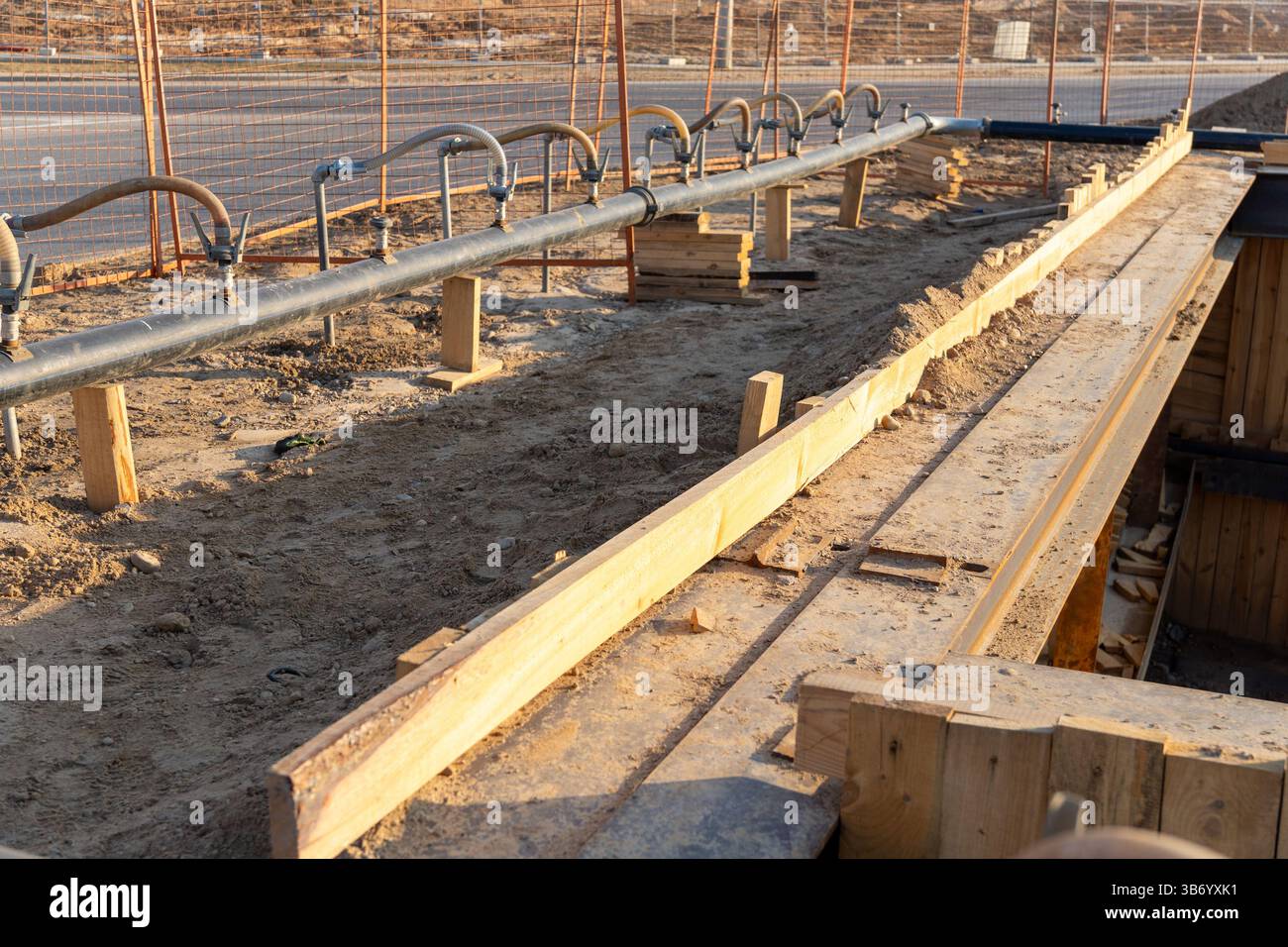 A close-up view of a series of flexible hoses connected to a pipe at a ...