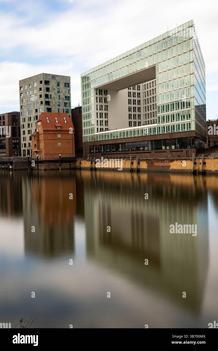 Reflecting on serene waters, contemporary glass structures contrast ...