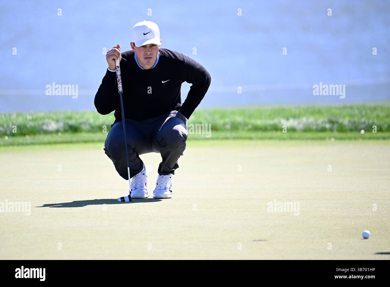 Davis Thompson lines up his putt on the sixth green during the first ...