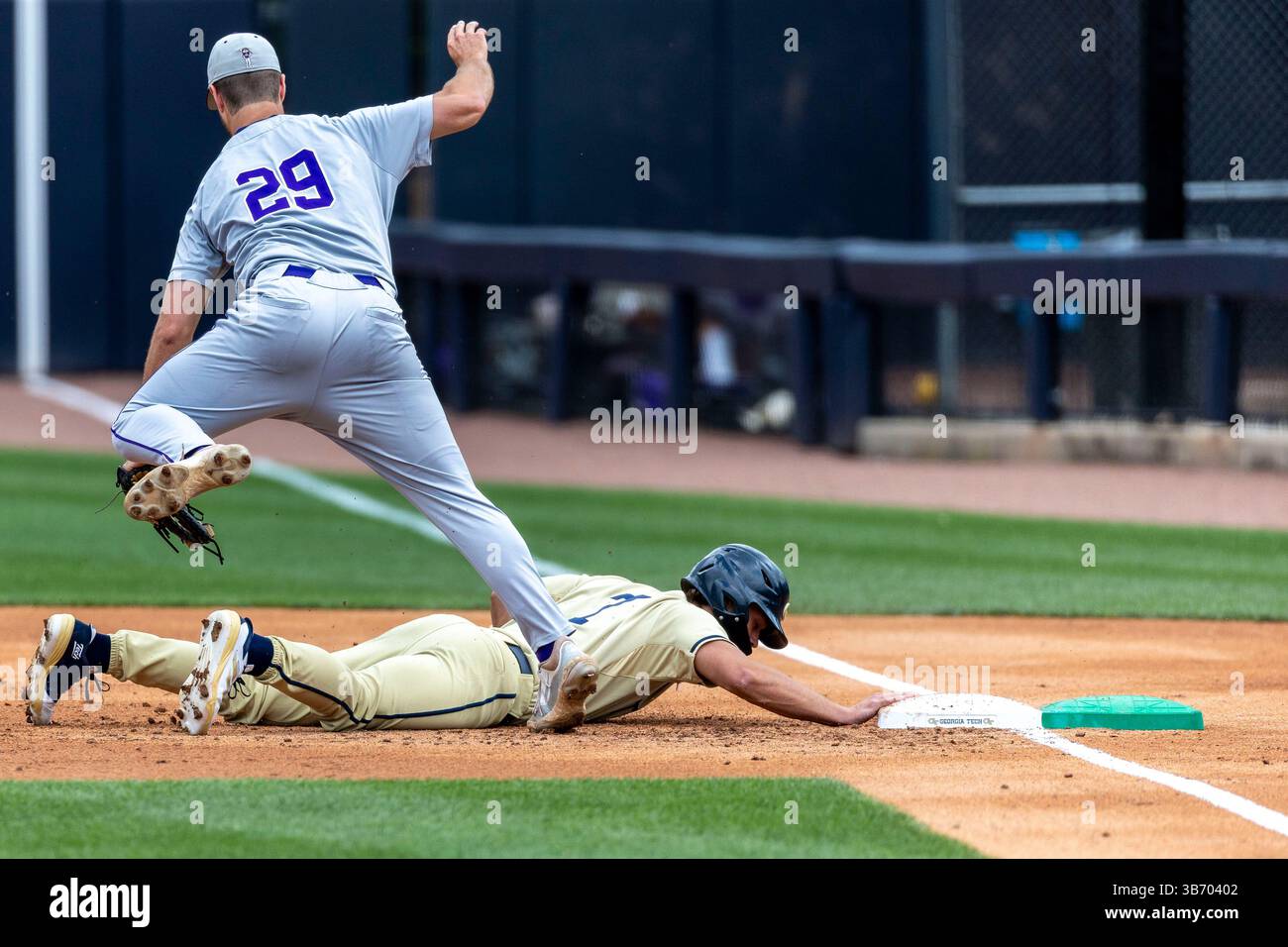 Georgia Tech infielder/utility Will Baker (7) dives back to first as ...