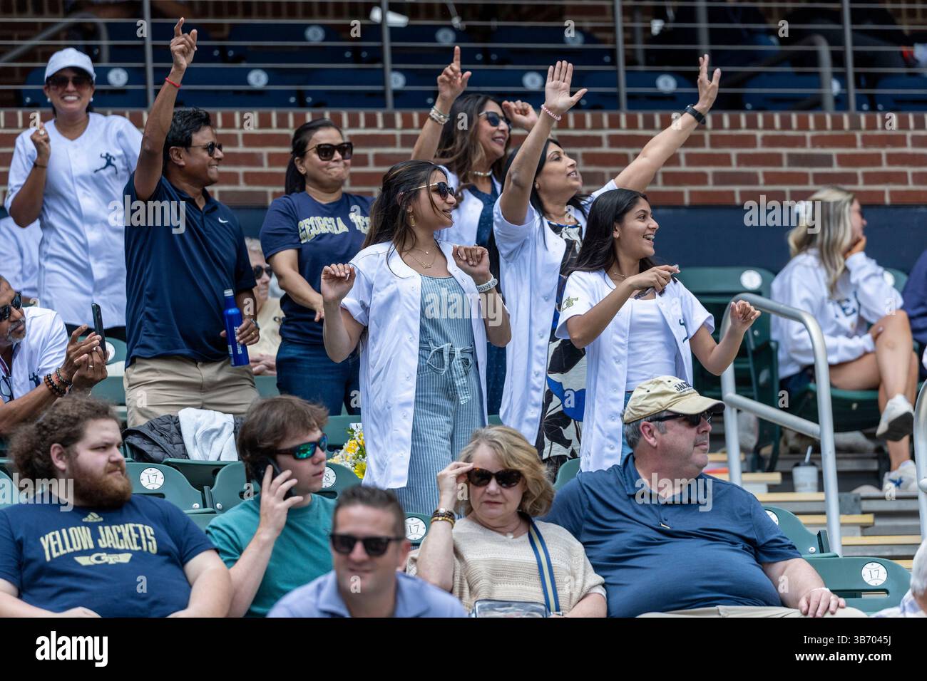 The family of Georgia Tech pitcher Mason Patel (29) cheers and dances ...