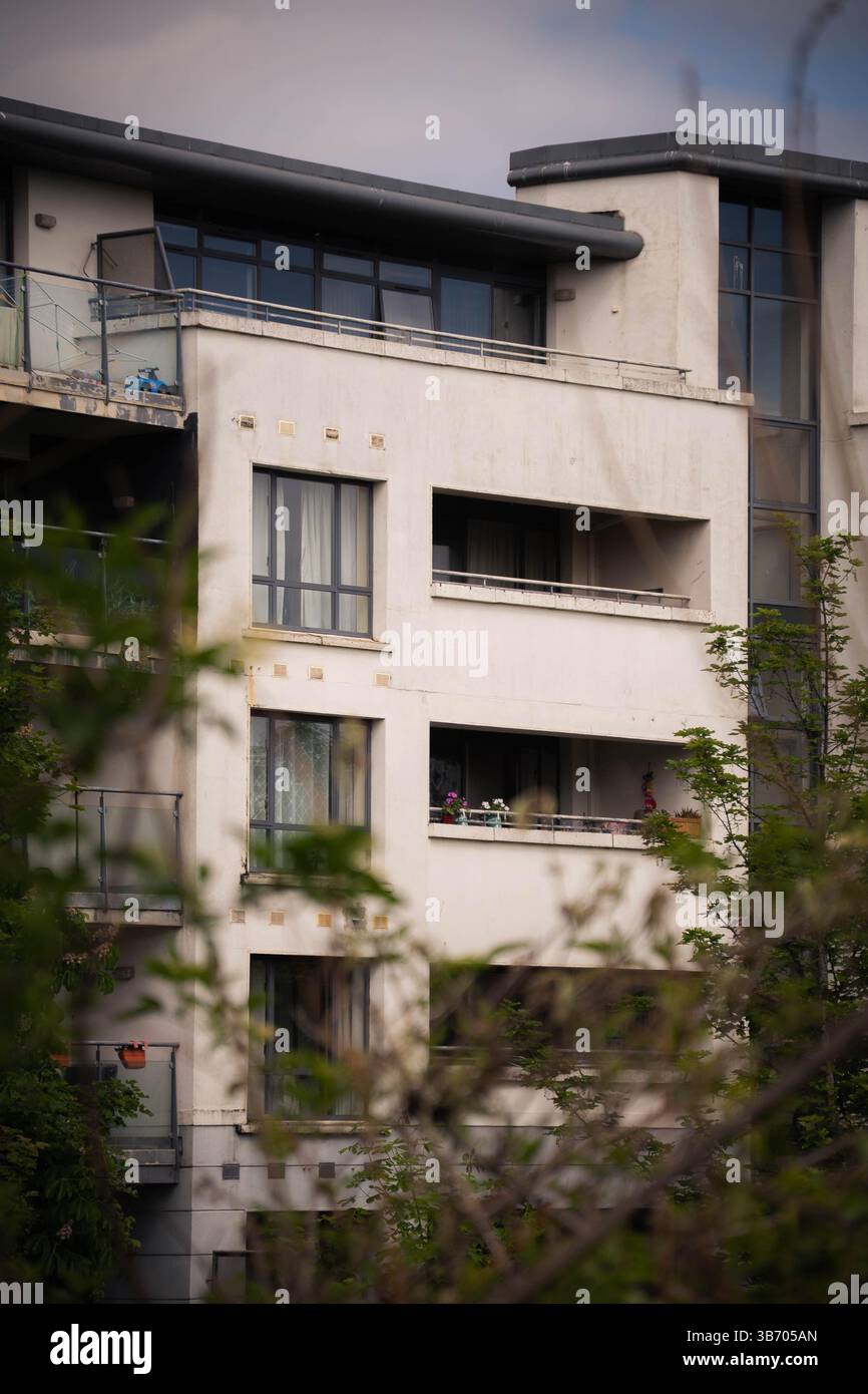 Modern apartment building with balconies and glass windows in a ...