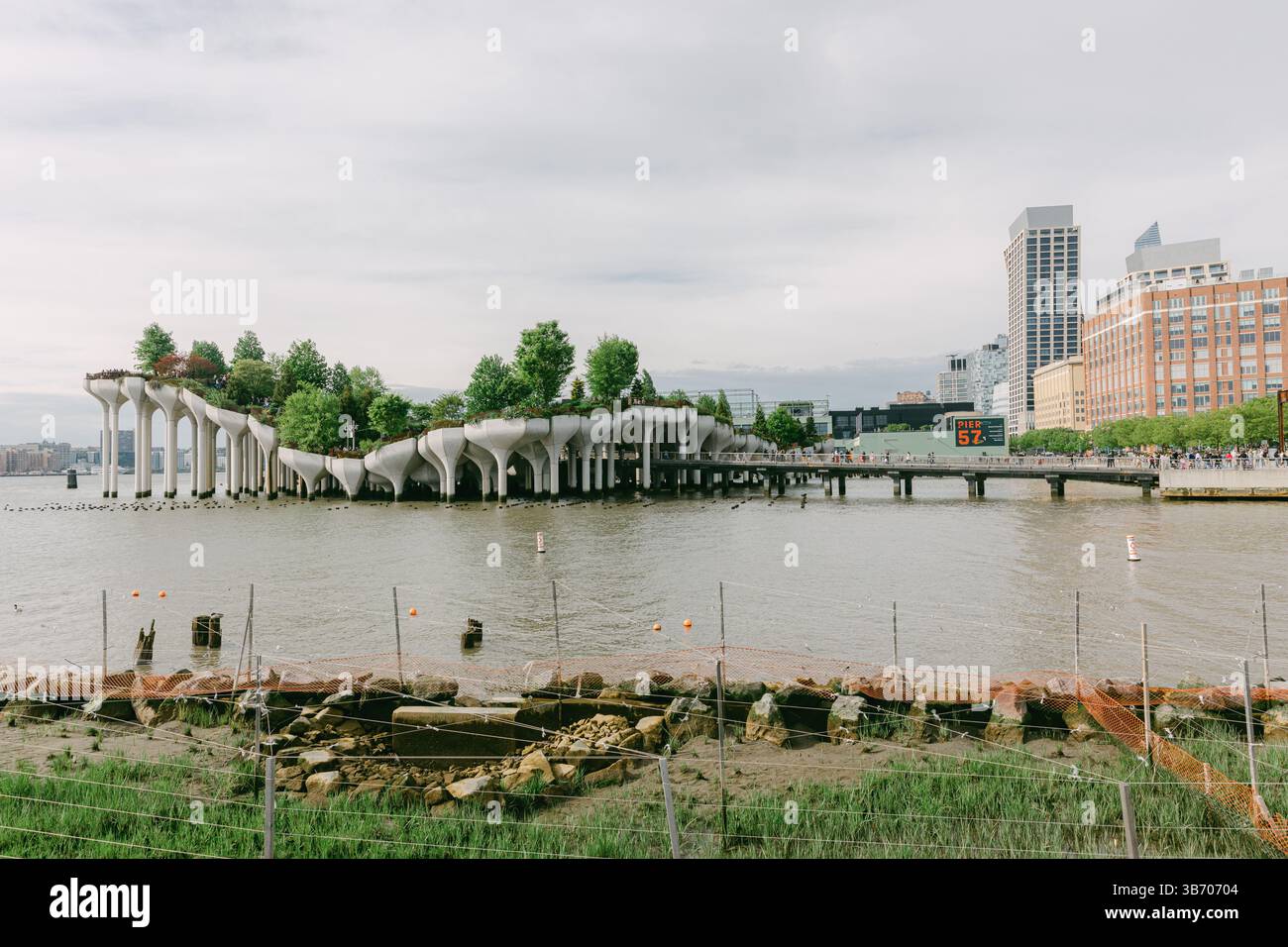 Visitors enjoy the scenic riverfront area with modern architecture and ...