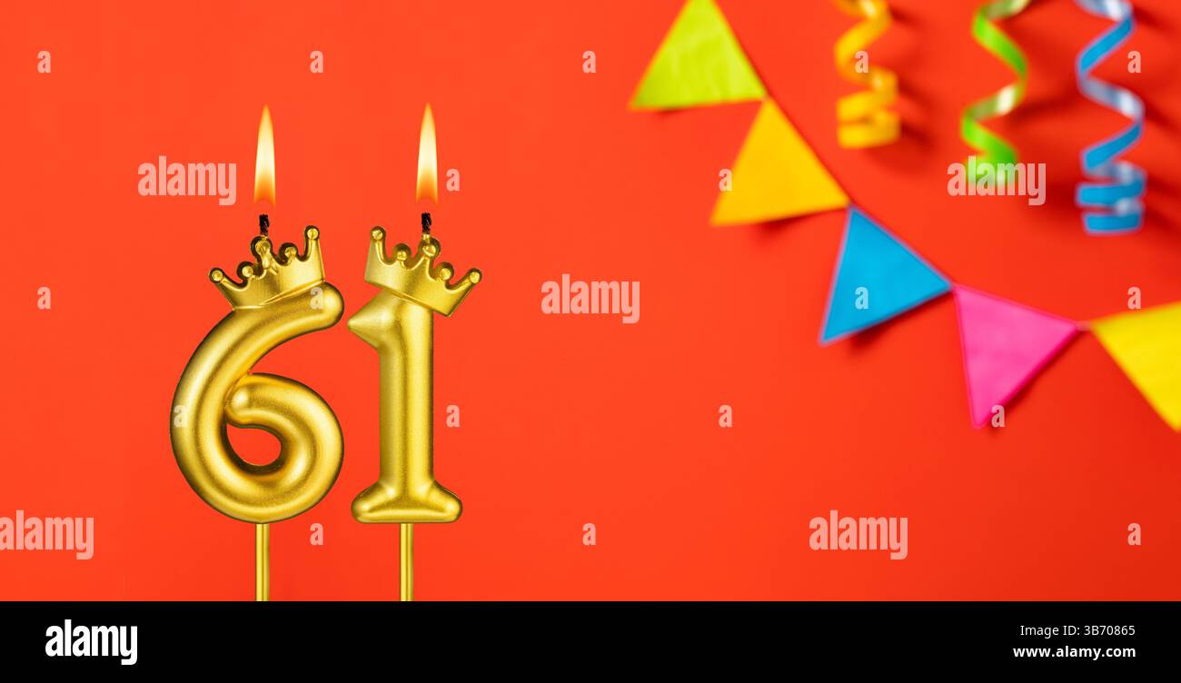 Number 61 birthday candle on an orange background with pennants Stock ...