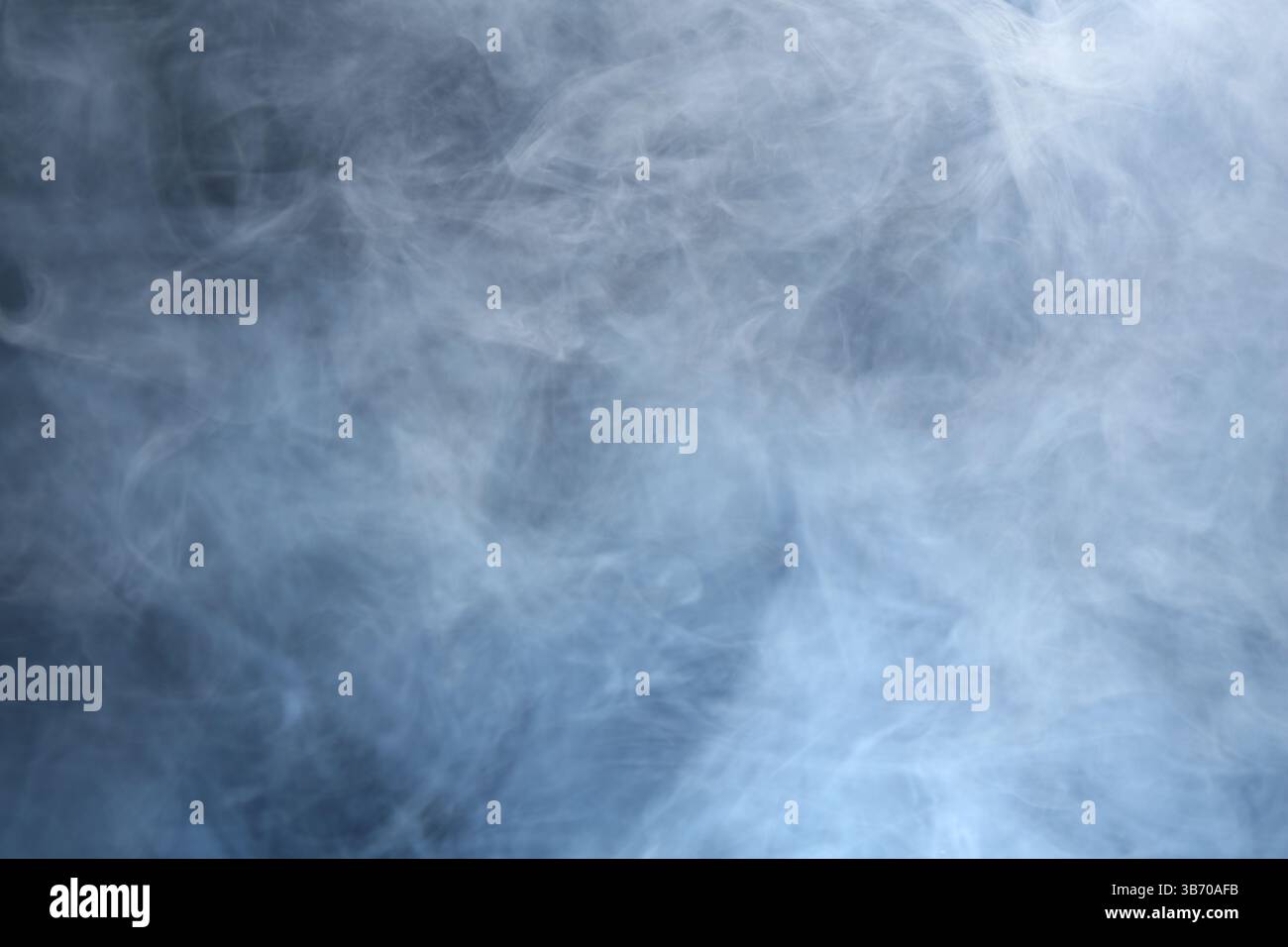 Beautiful smoke in lights on dark background Stock Photo - Alamy