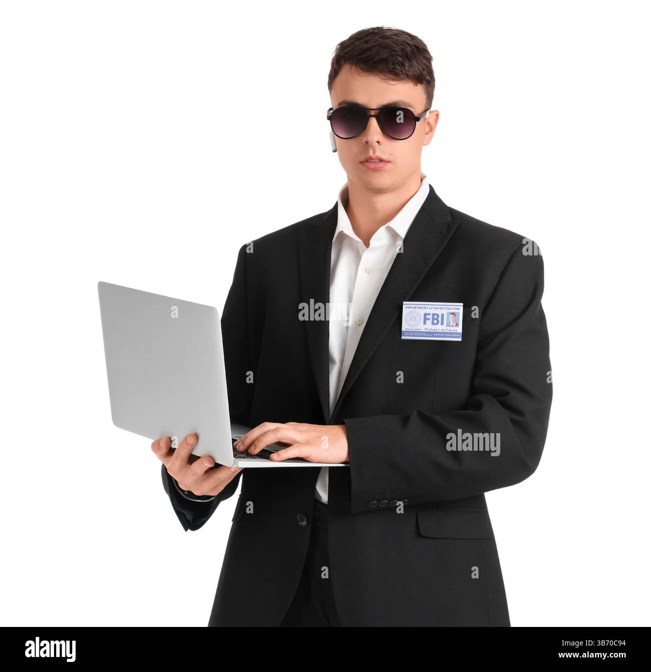 Male FBI agent in sunglasses using laptop on white background Stock ...
