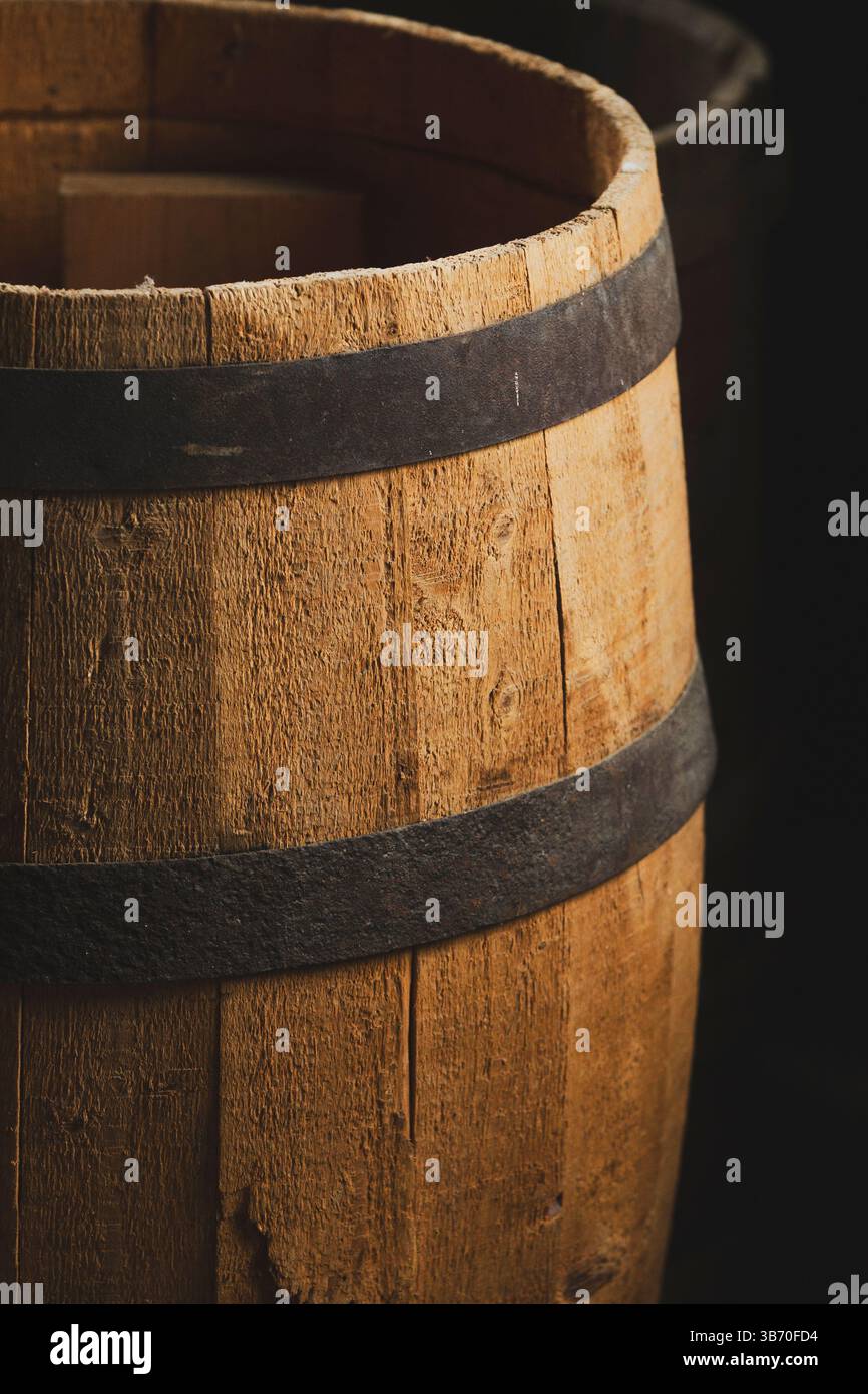 Rustic wooden barrel with aged metal bands in low light Stock Photo - Alamy