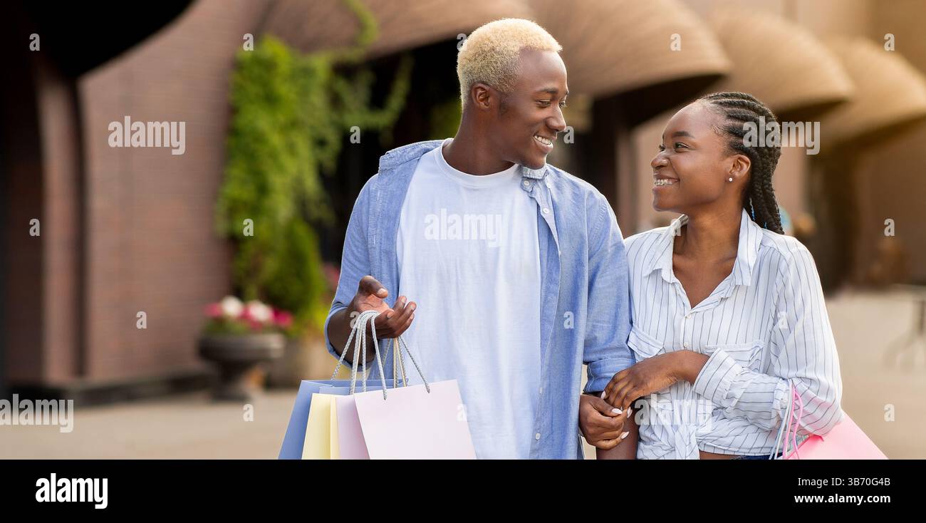 Consumerism, love and lifestyle. Beautiful young couple enjoying ...