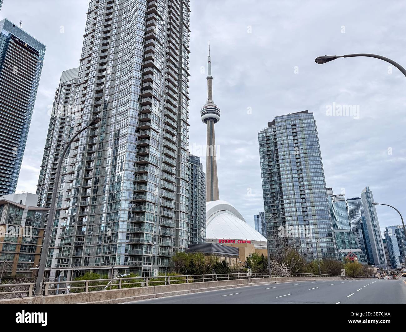 CN Tower and Rogers Centre viewed from street level in downtown Toronto ...