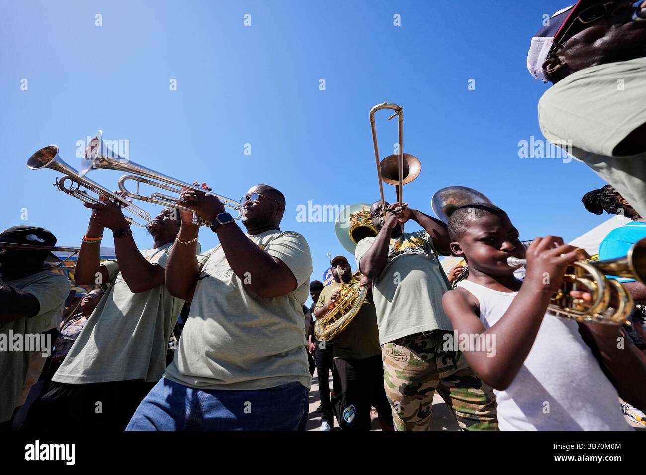 Members of the New Generation Brass Band perform in a second line ...