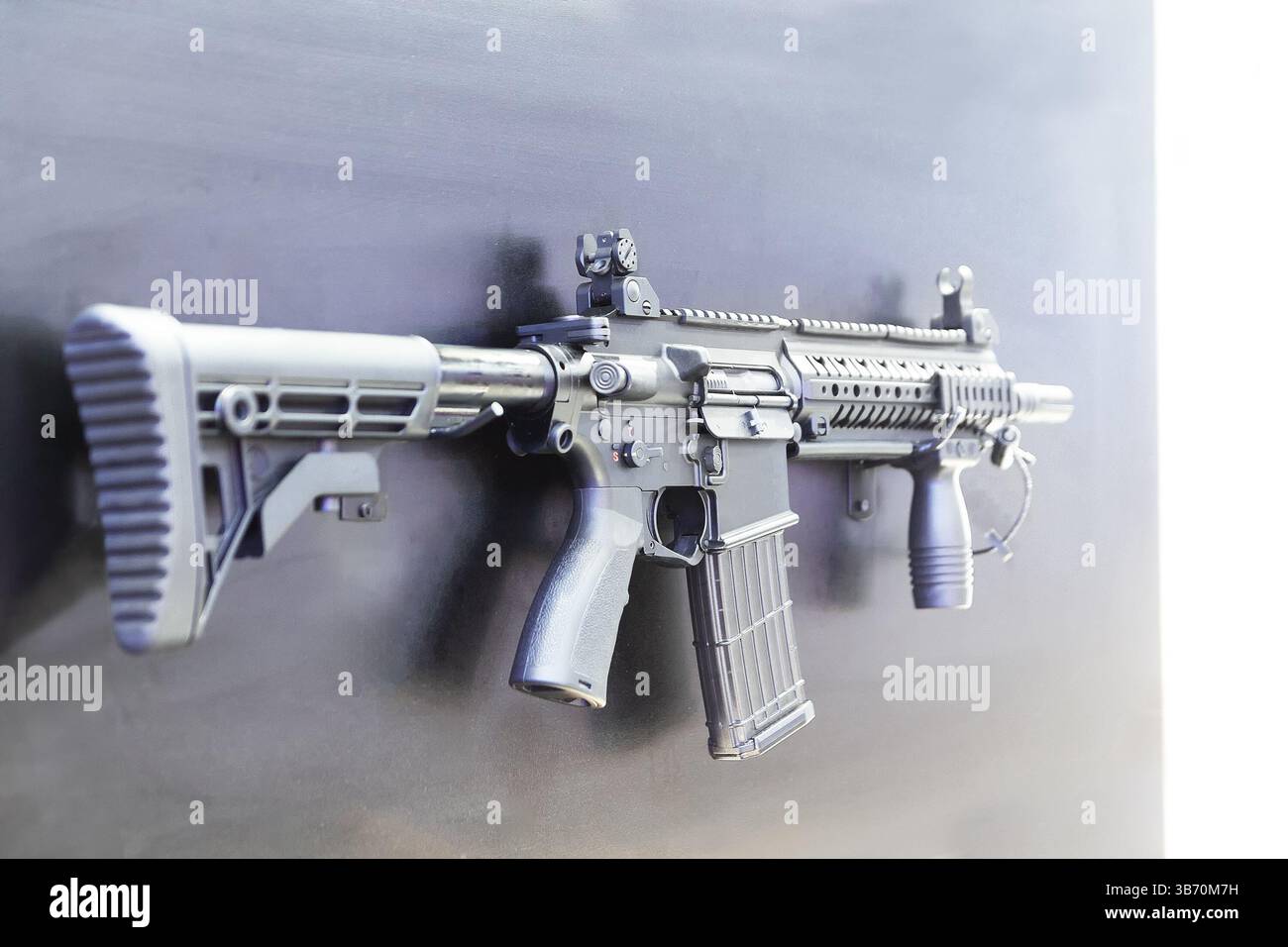 Automatic rifle with a high grenade launcher on the window of the ...