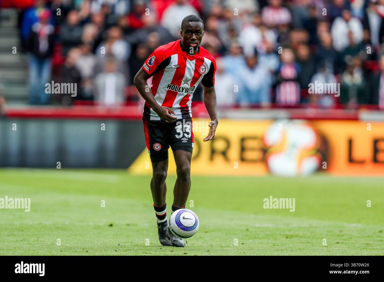 London, UK. 04th May, 2025. Michael Kayode of Brentford passes the ball ...