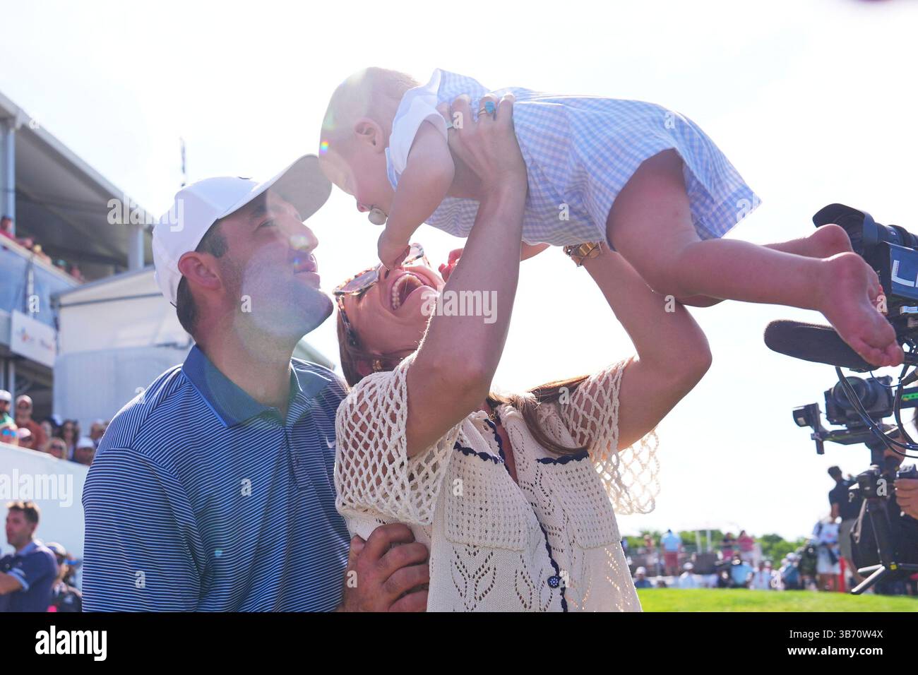 Scottie Scheffler, left, is greeted by his wife Meredith, center, and ...