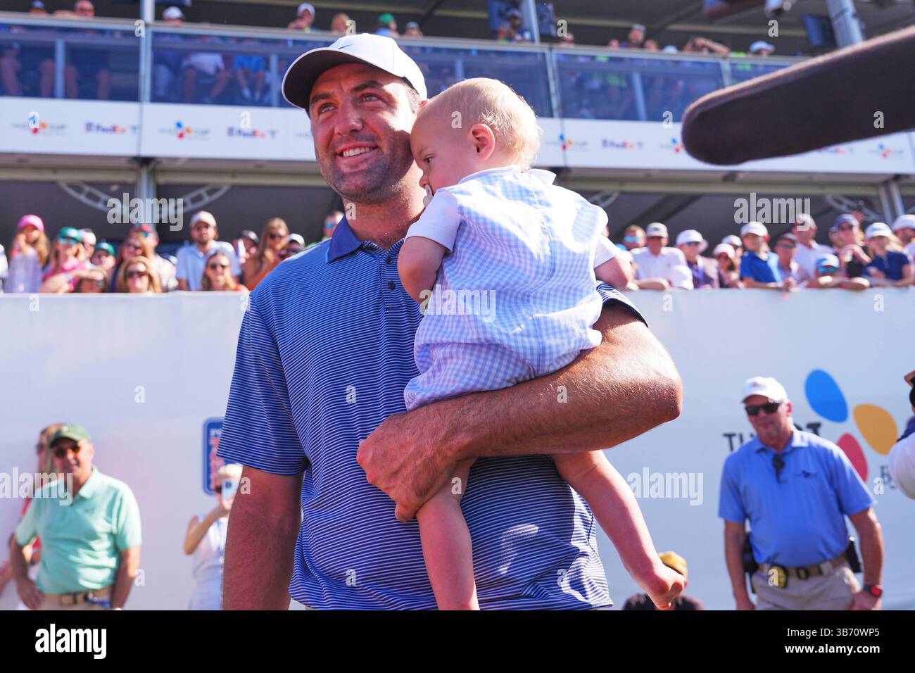 Scottie Scheffler, front left, holds his son Bennett after winning the ...