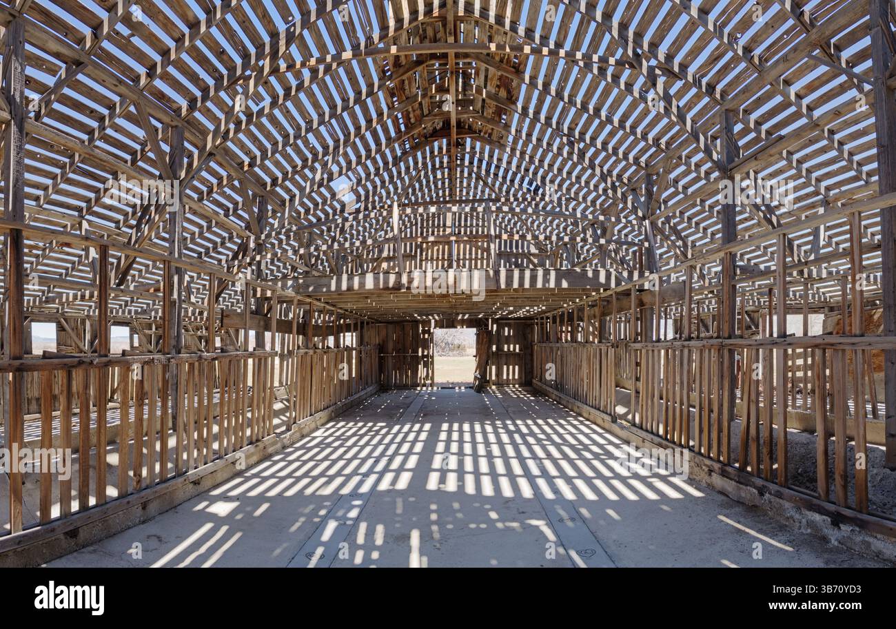 wide angle image of interior of old abandoned barn with missing roof ...