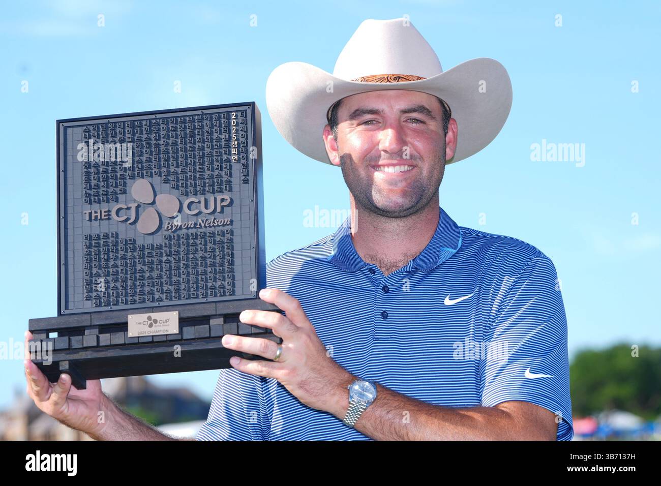 Scottie Scheffler holds the winner's trophy of the CJ Cup Byron Nelson ...