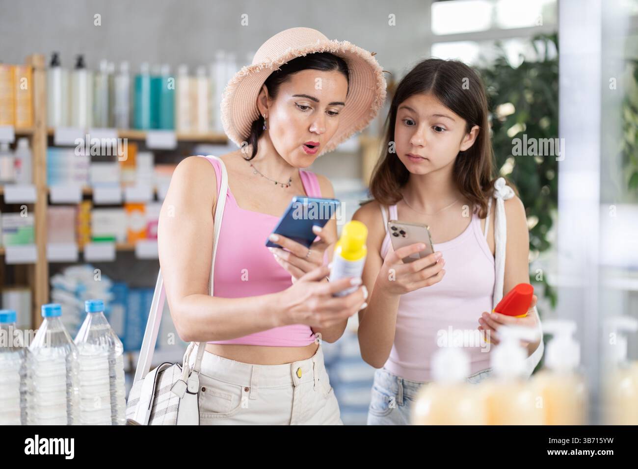 Mom and daughter scanning barcode on repellent in chemist shop Stock ...