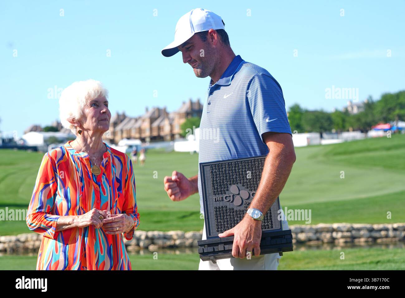 Scottie Scheffler, right, has a moment with Peggy Nelson, left, the ...