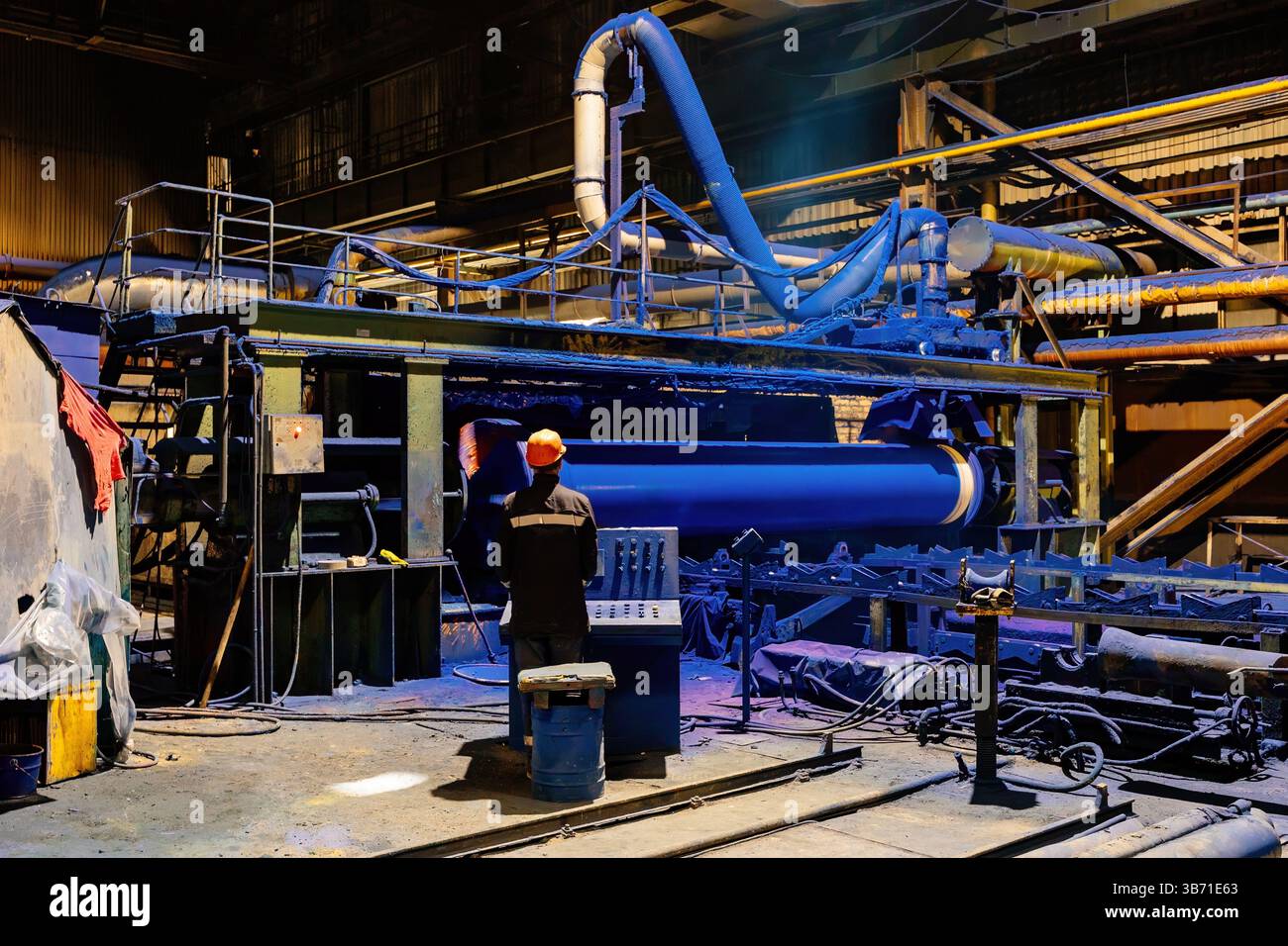 Factory engineer operates pipe painting automatic machine Stock Photo ...