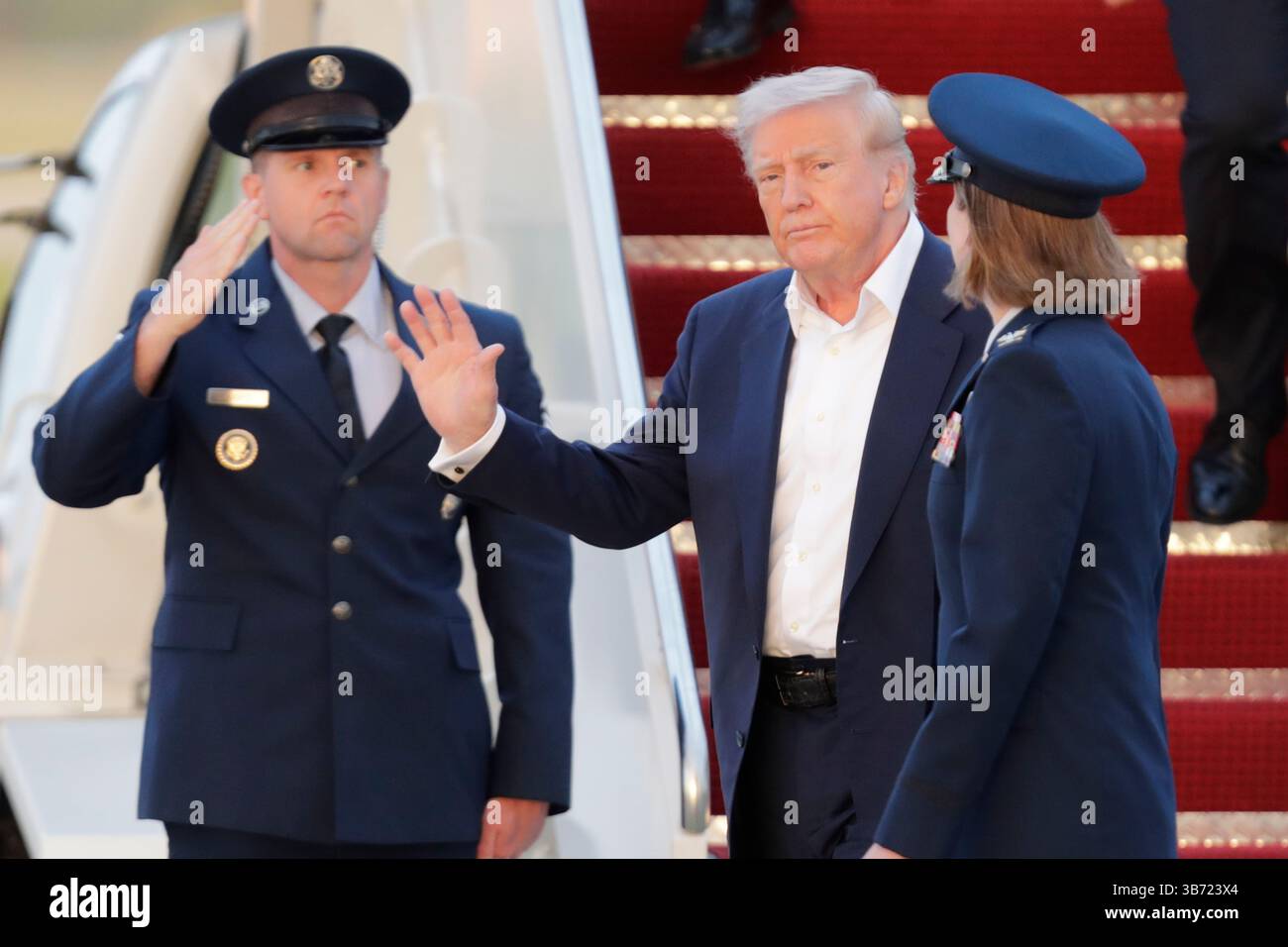 President Donald Trump is greeted by Air Force Col. Angela F. Ochoa ...