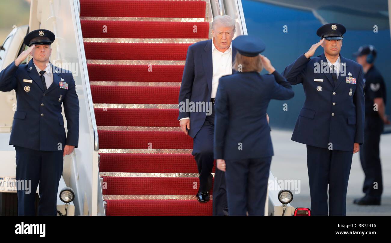 President Donald Trump is greeted by Air Force Col. Angela F. Ochoa ...