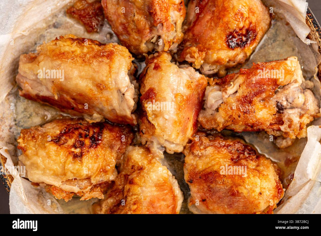 Top view of perfectly fried chicken thighs with heavily textured crust ...