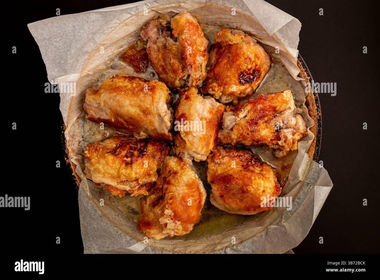 Top view of perfectly fried chicken thighs with heavily textured crust ...