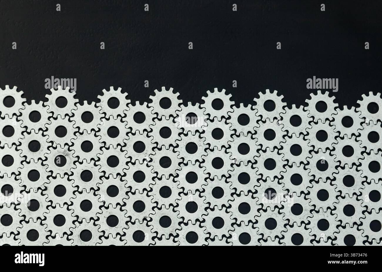 Gear background. A large number of steel gears connected to each other ...