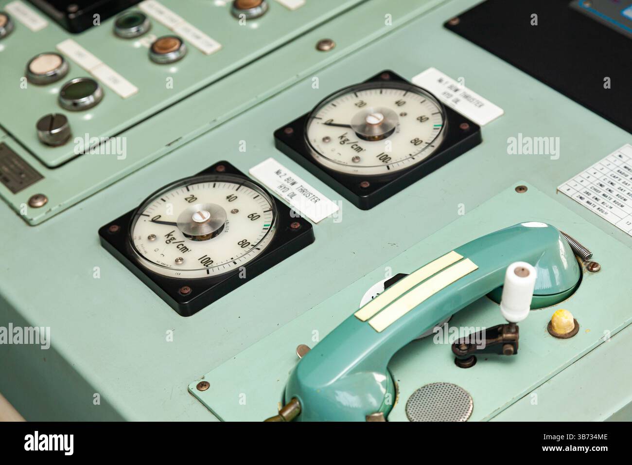 Boat control panel with analog corded telephones, buttons, switches and ...
