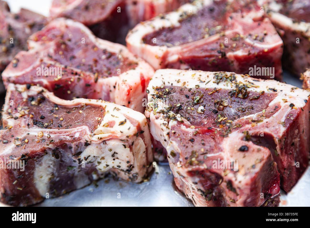 Pieces of juicy, fresh beef in spices, close-up. Beef raw steaks, top ...