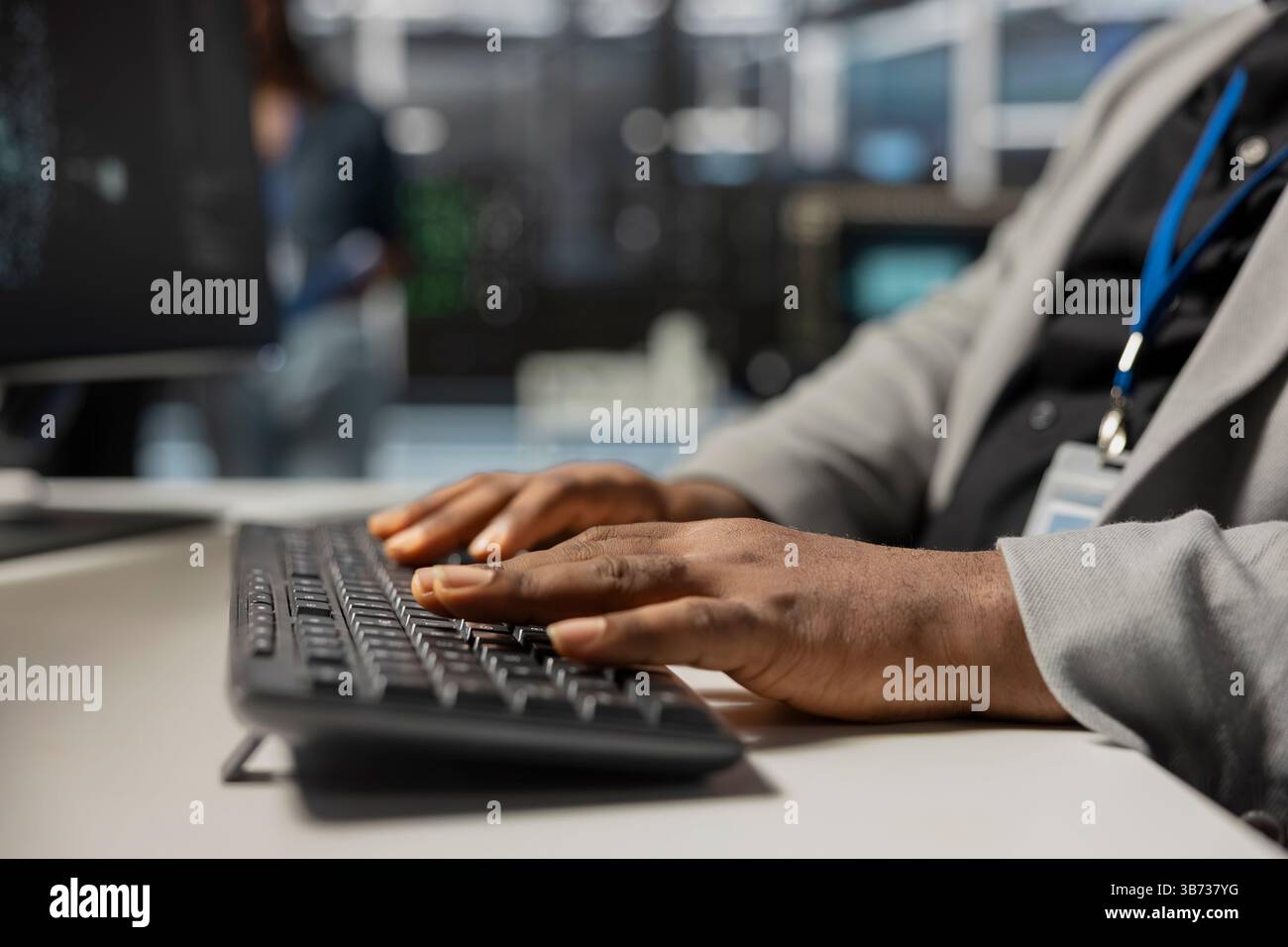 Close up of data center technician typing on keyboard, inspecting gear ...