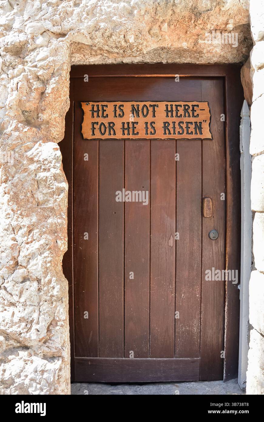 Empty tomb of Jesus Christ. Wooden door bearing the words, He is not ...