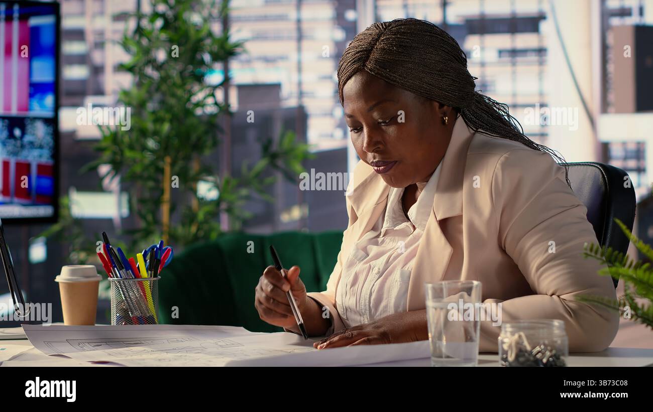 Black female director evaluating architecture hi-res stock photography ...