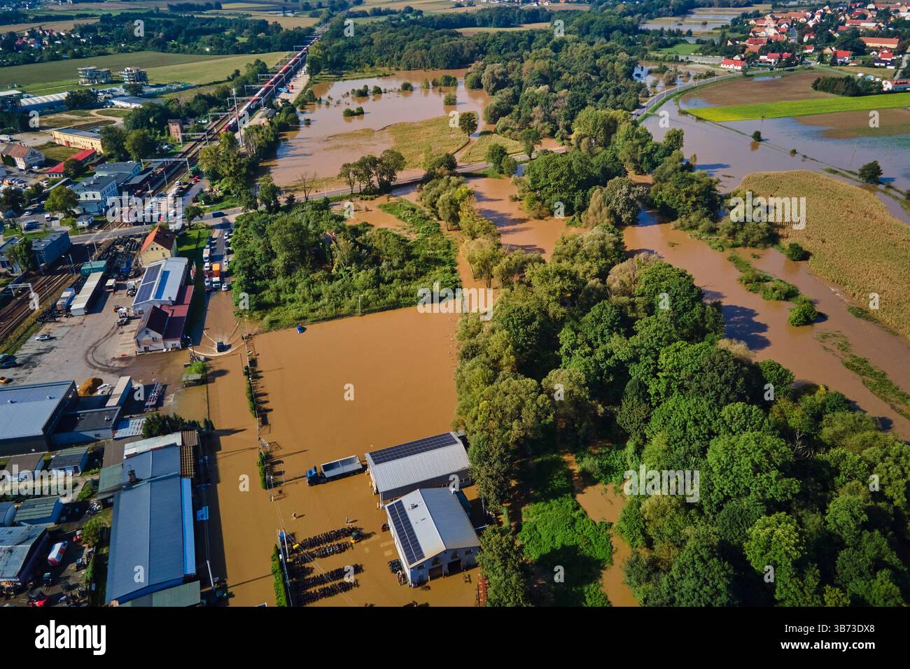 Aerial view of flooded streets, railway tracks and buildings in a ...