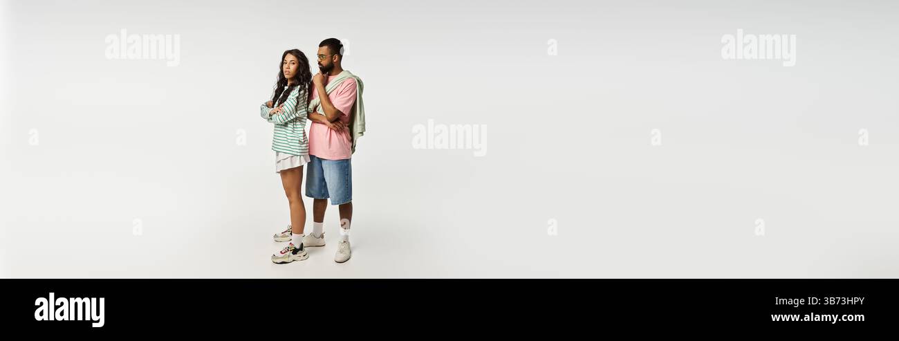A couple poses confidently, expressing their unique style while sharing ...