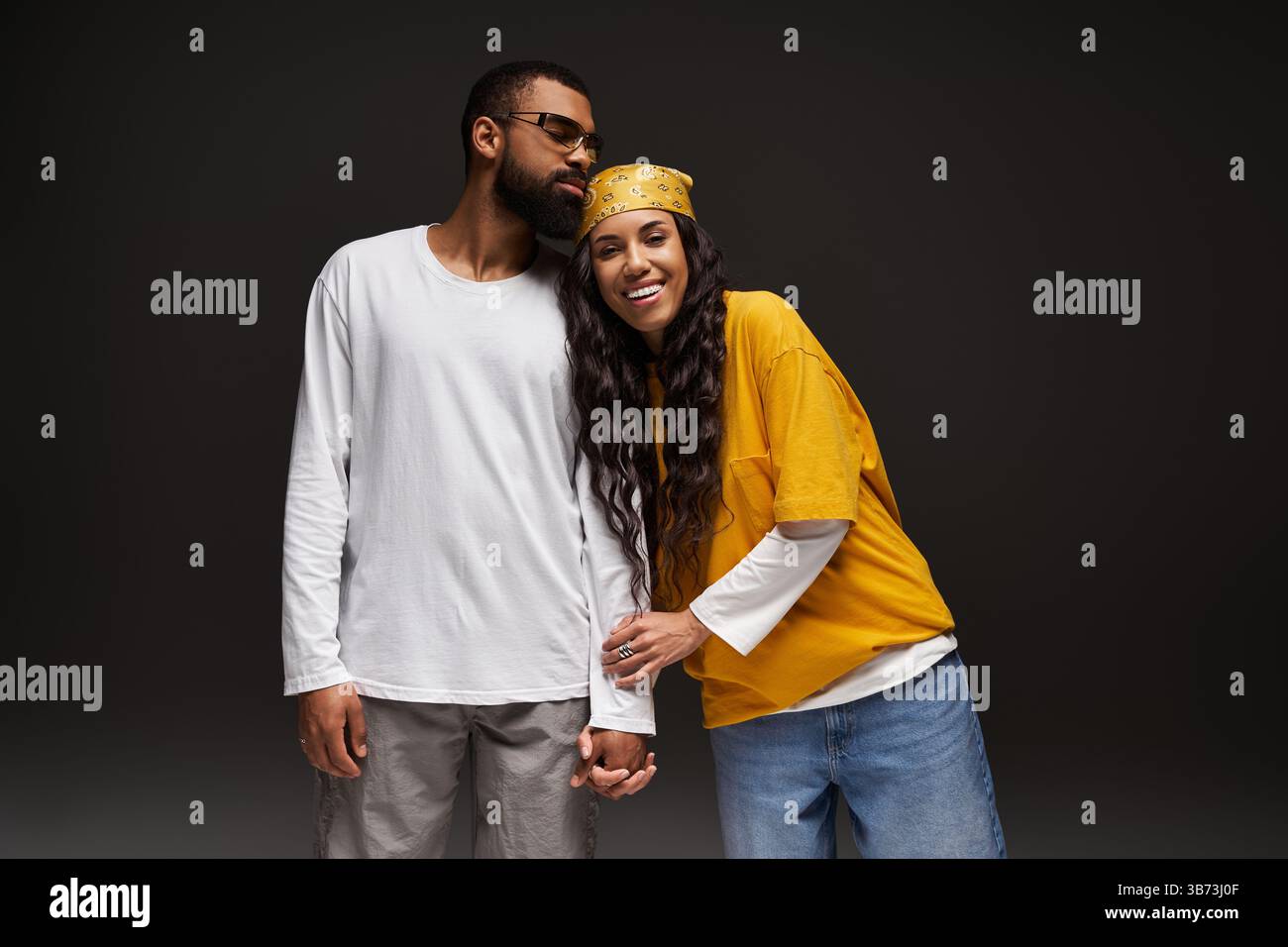 A stylish couple shares a joyful moment, expressing love through their ...