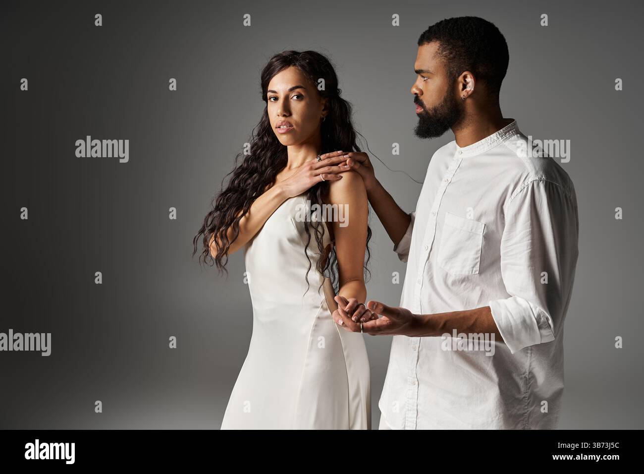 A stylish couple shares an intimate moment in a modern setting Stock ...