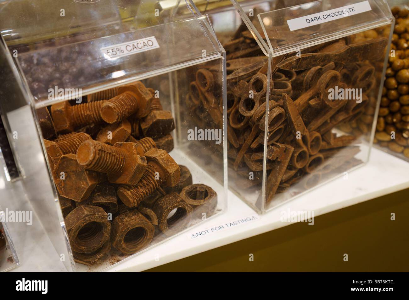 Unique Belgian chocolate shaped like nuts and bolts on display in a ...