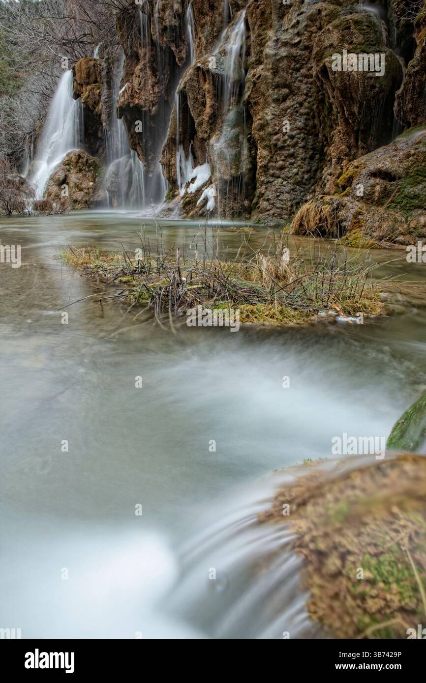 Waterfalls over jutting rocks at the source of the Cuervo river in ...