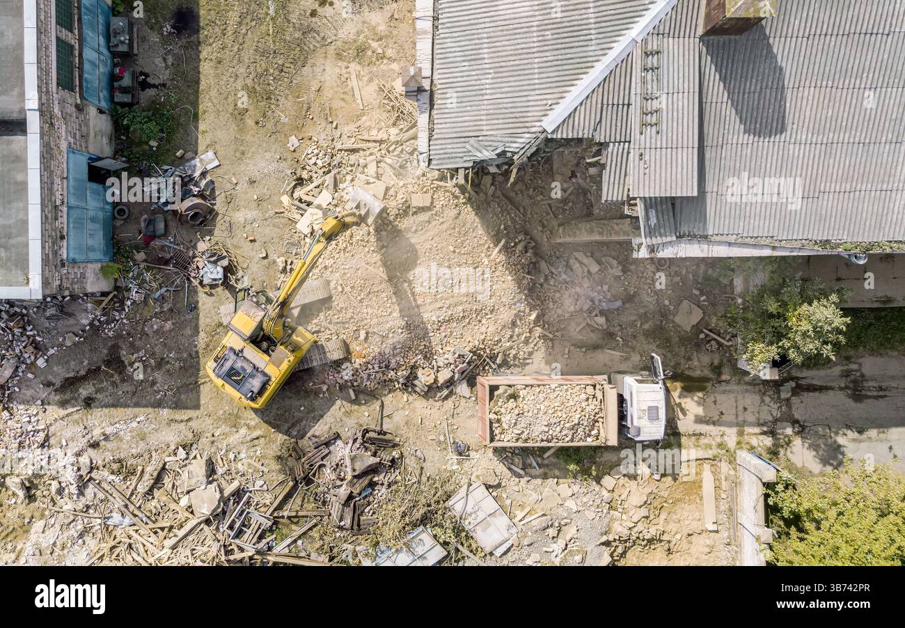 loading by excavator of construction debris of the old building after ...