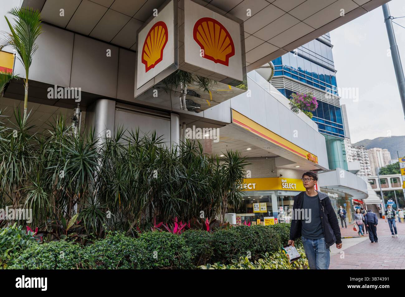 Hong Kong, China. 26th Mar, 2025. A man walks past a Shell station, one ...