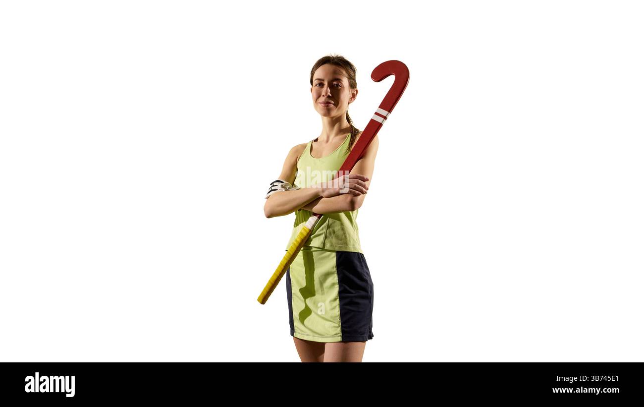 Confident female player standing upright with crossed arms and stick on ...