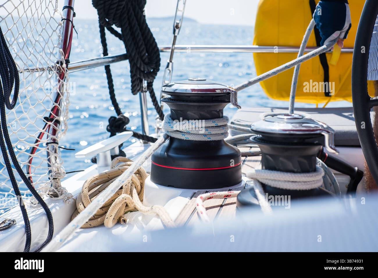 Sailing yacht ropes and winch. Sailboat equipment details. Water ...