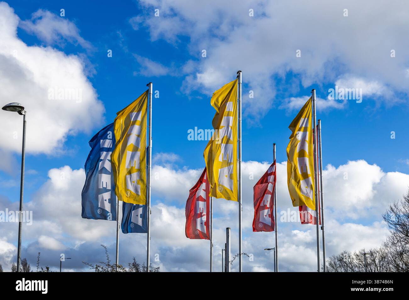 IKEA store front with multiple company flags flying on poles outdoors ...