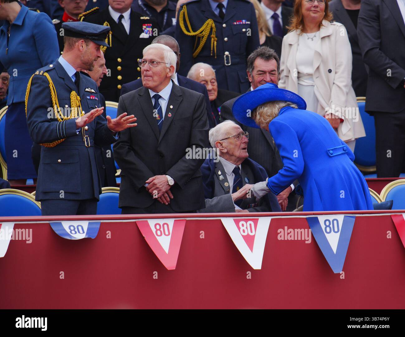 The Prince of Wales speaks to a representative from the Royal British Legion as Queen Camilla ...