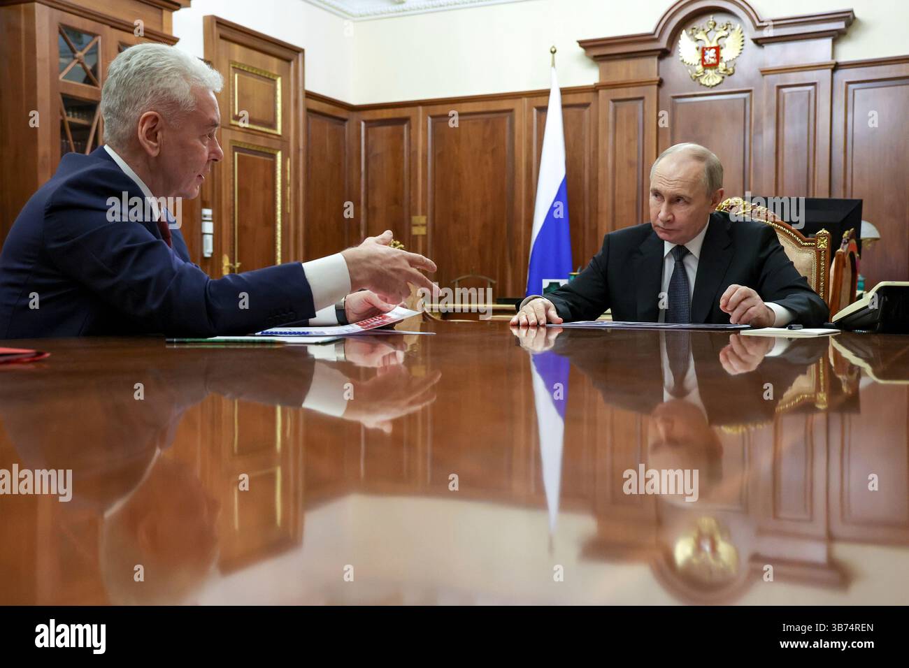 Russian President Vladimir Putin, right, listens to Moscow Mayor Sergei ...