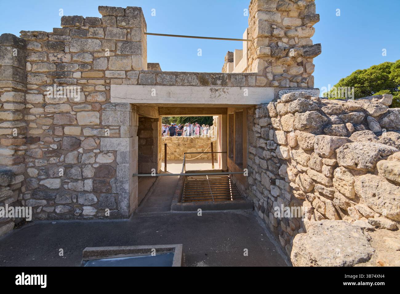Crete.Greece - may 05, 2025: Tourists pass through the weathered stone ...