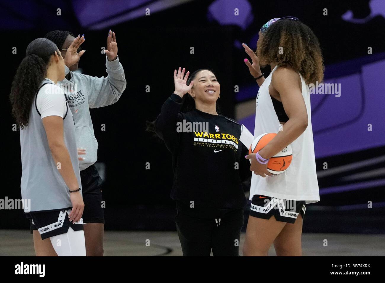 Golden State Valkyries head coach Natalie Nakase, middle, high fives ...