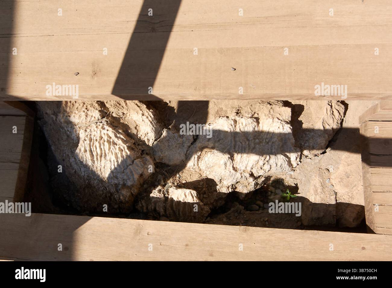 Exposed layers of stone and wooden beams reveal the ongoing excavation ...